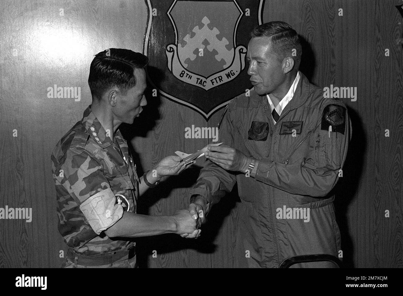 COL James Record, commander of the 8th Tactical Fighter Wing, presents ...