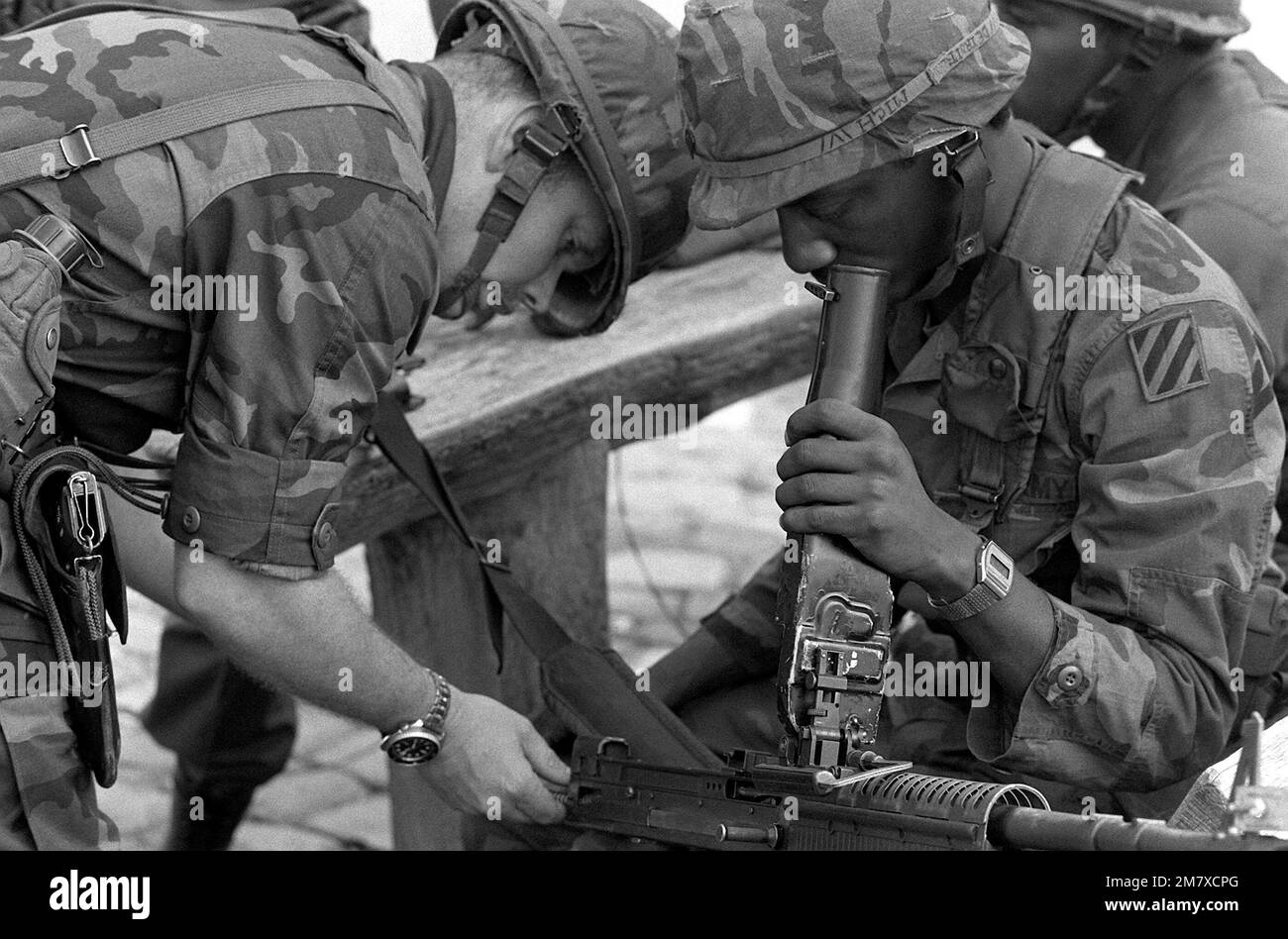 CPT Thomas Sutton of the 3rd Infantry Division, assist SPC 4 Stanley ...