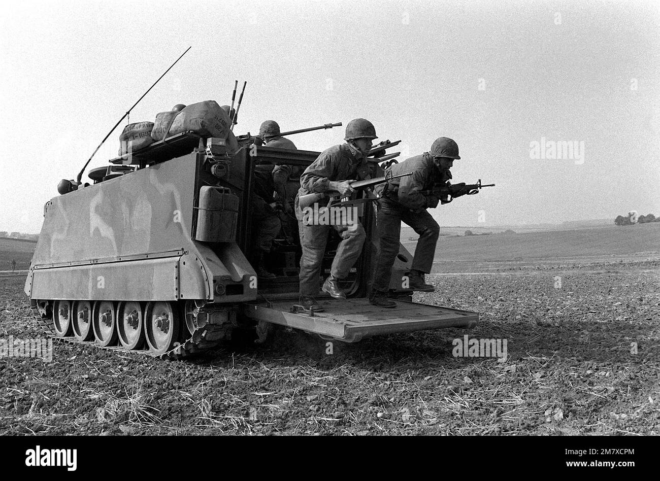 Members of Co. B, 1ST Bn., 28th Inf., charge out the back of an armored ...