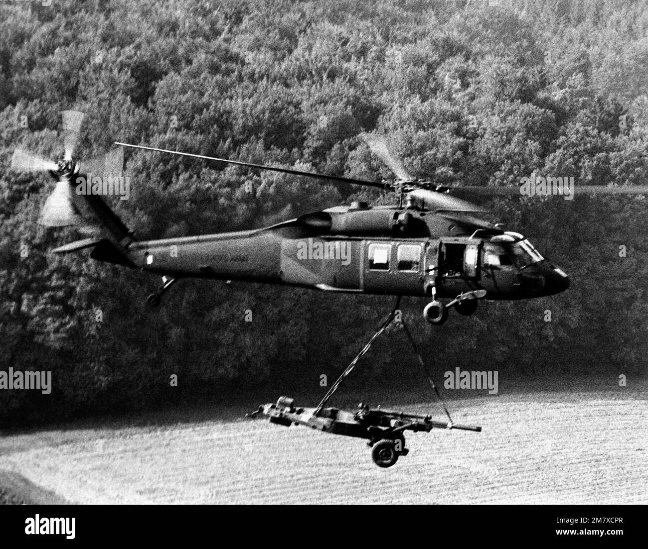 A U.S. Army UH-60A Black Hawk helicopter is used to airlift an M-102 ...