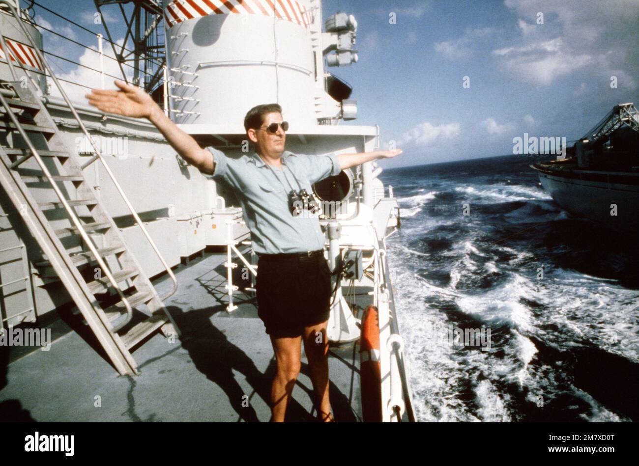 A signalman aboard HMCS IROQUOIS (DDH-280) waves a message to the flag ...