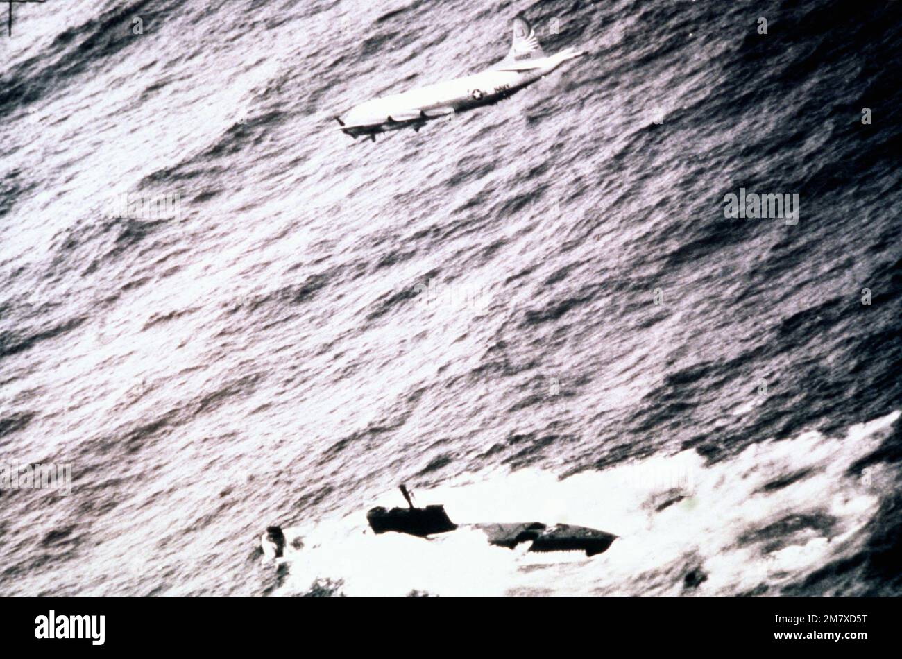 A P-3C Orion aircraft in flight over a Soviet Juliett class submarine ...