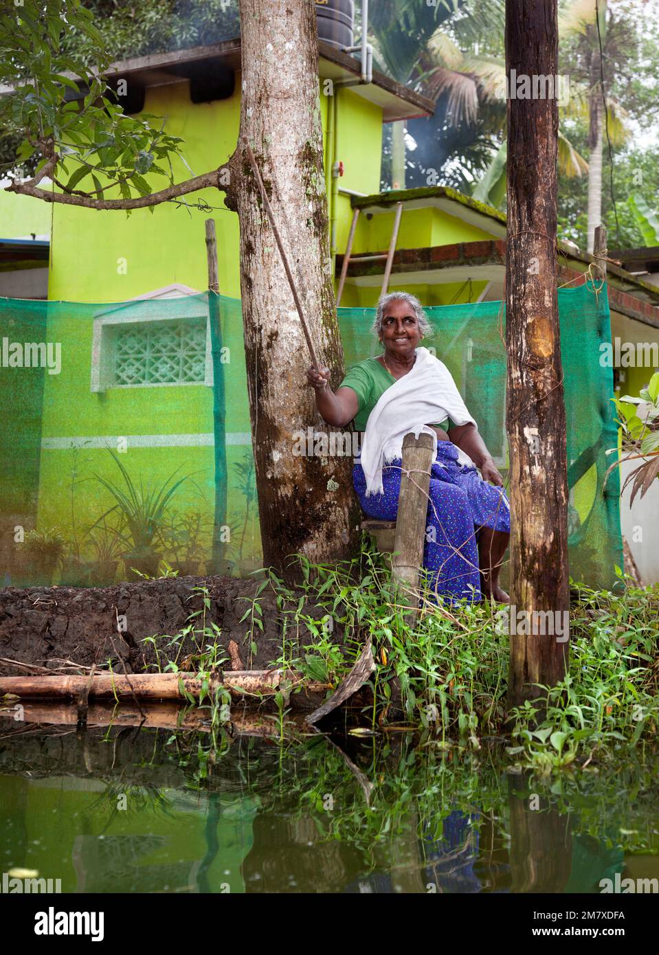 Allepey, India-September 7, 2012. An Indian woman while fishing with a ...