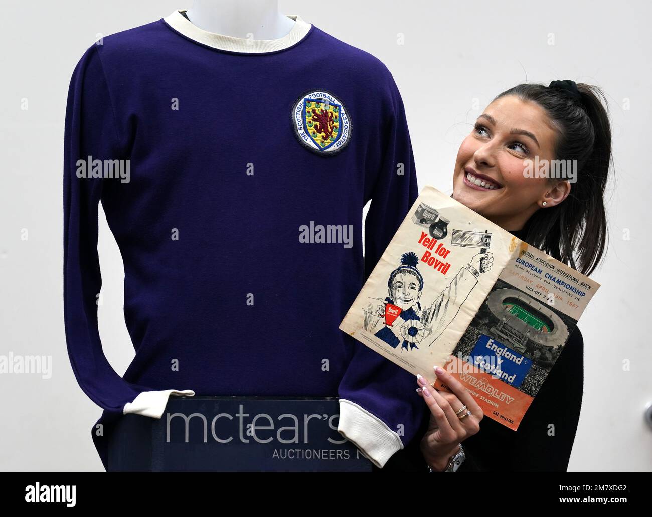 Auctioneer Amy Cameron with Jim Baxter's match worn jersey from ...