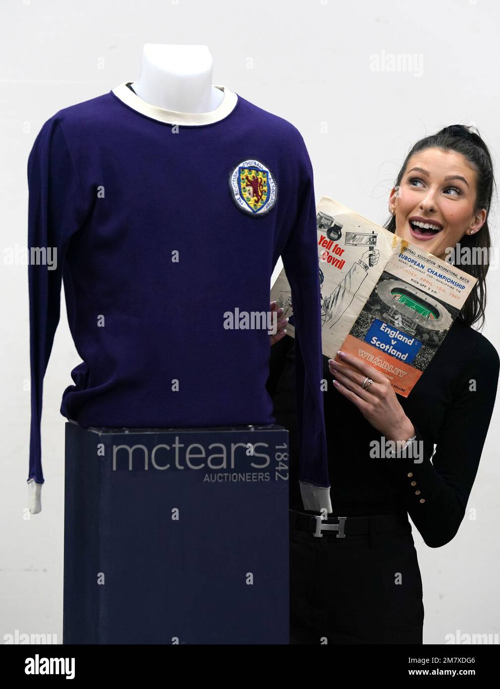 Auctioneer Amy Cameron with Jim Baxter's match worn jersey from ...