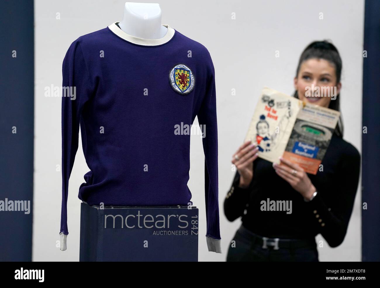 Auctioneer Amy Cameron with Jim Baxter's match worn jersey from ...