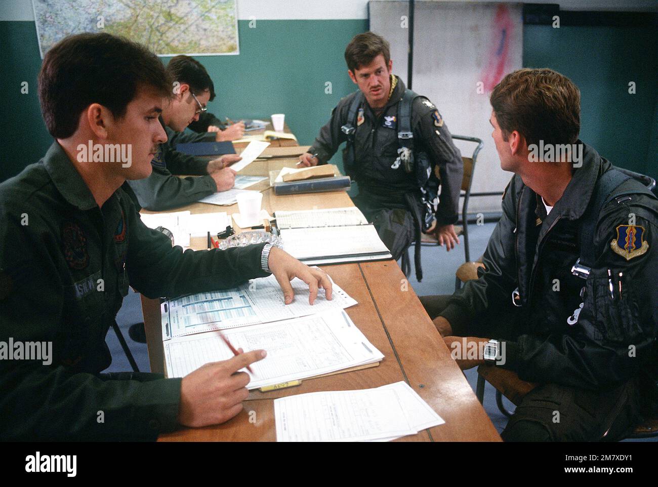Pilots participate in a post-flight debriefing during Reforger-Crested ...