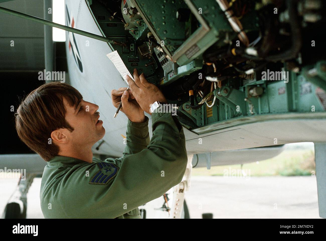 SSGT Robert Olesen checks the internal components of an F-15 Eagle ...