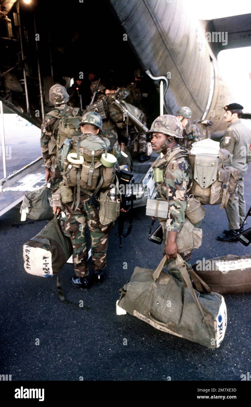 Members of the 1ST Cavalry board a C-130 Hercules aircraft for ...