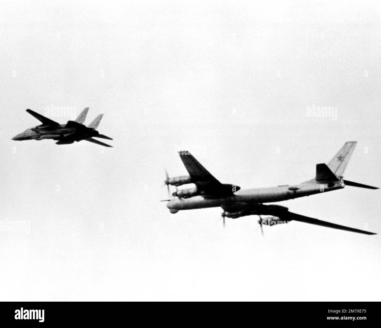 A left underside view of an F-14A Tomcat aircraft escorting a Soviet Tu ...