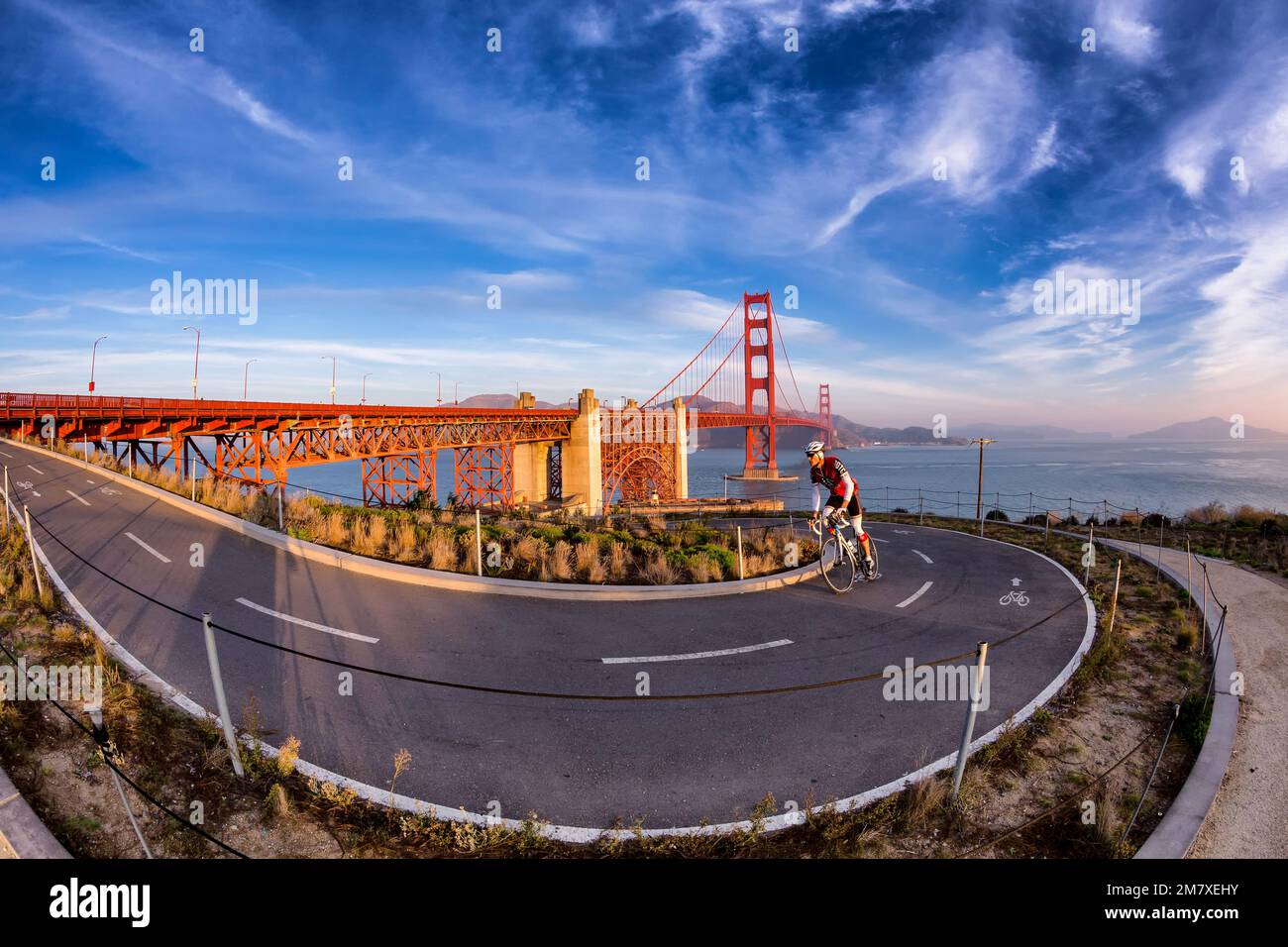 Cyclist on the bike path approach to Golden Gate Bridge. In the ...