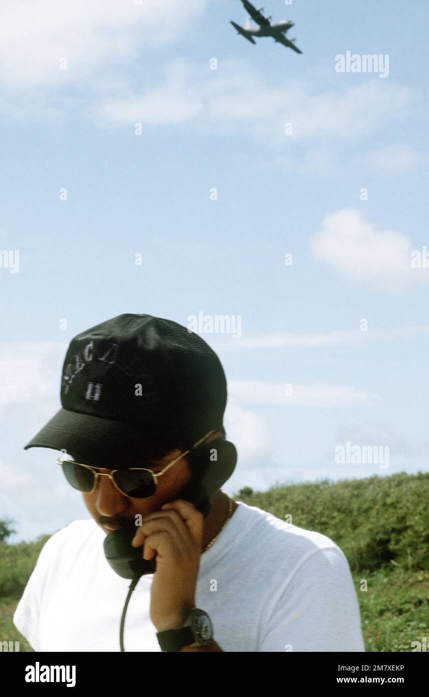 CPT Hesebi of the Airlift Control Element (ALCE) communicates by radio ...