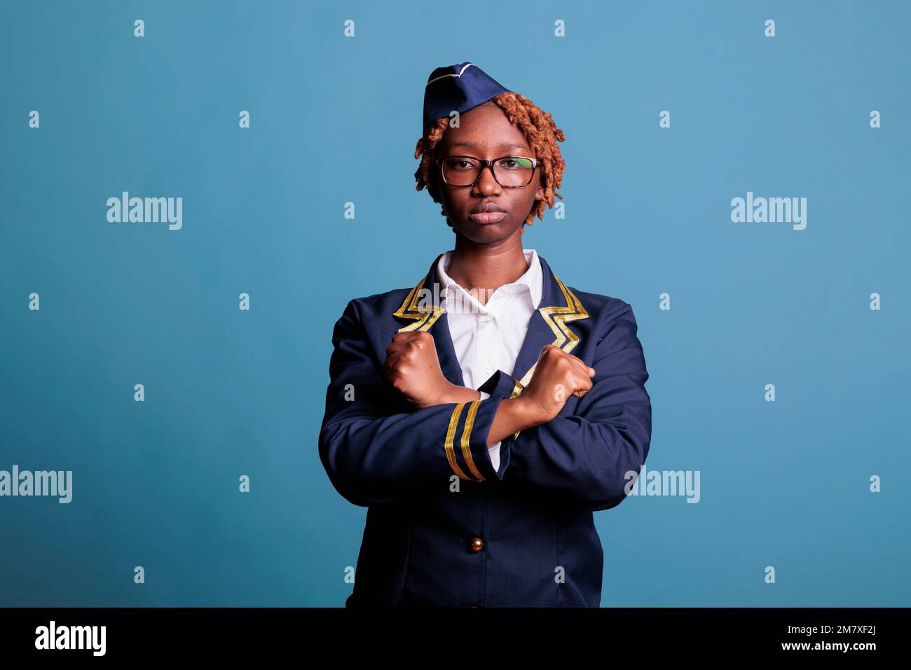 African american disapproving flight attendant making a stop gesture ...