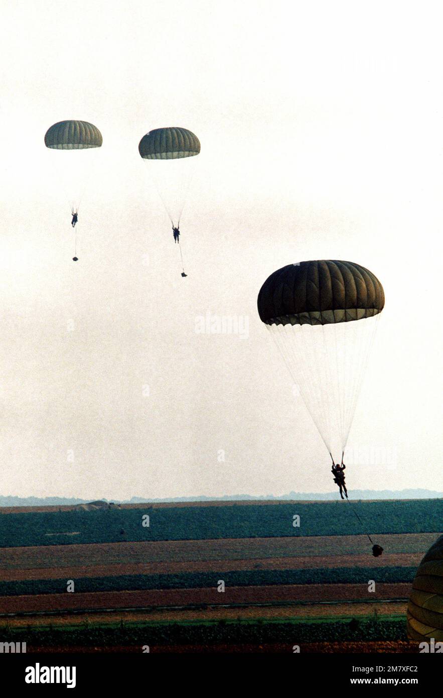 Troops of the 82nd Airborne Division are air-dropped from C-141 ...