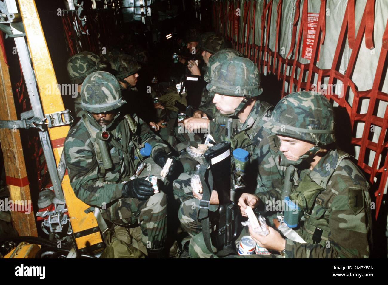 Members of the 63rd Armor, aboard a C-130 Hercules aircraft, dine on ...