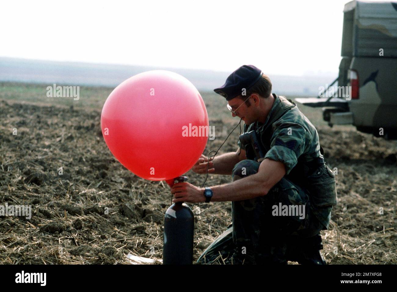 STAFF Sergeant Jerry Rugg of the 2nd Weather Wing inflates a balloon to ...