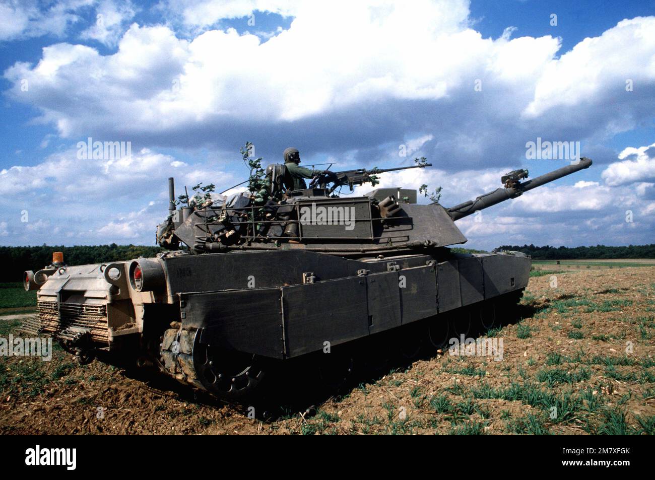 A right rear view of an M-1 main battle tank in use during exerecise ...