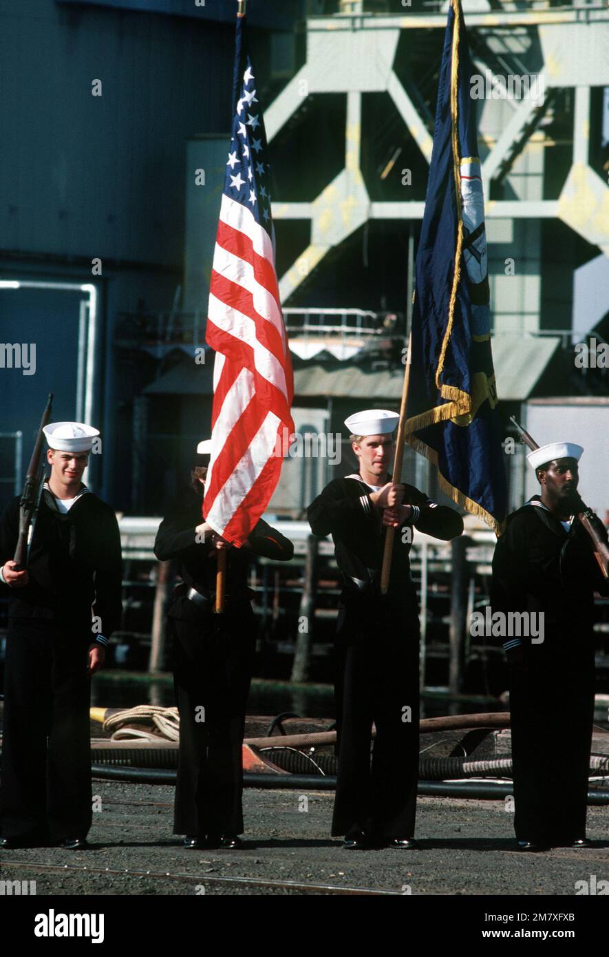 An honor guard displays the colors during the commissioning ceremony ...
