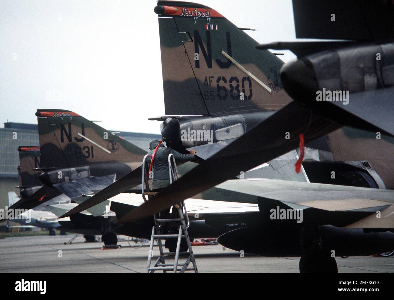 SSGT Roberto Quinones packs a drag chute into the rear of an F-4 ...
