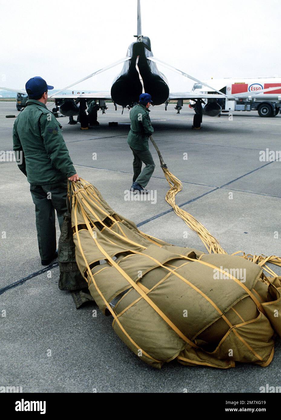 Two Air National Guardsmen remove a drag chute from an F-4 Phantom II ...