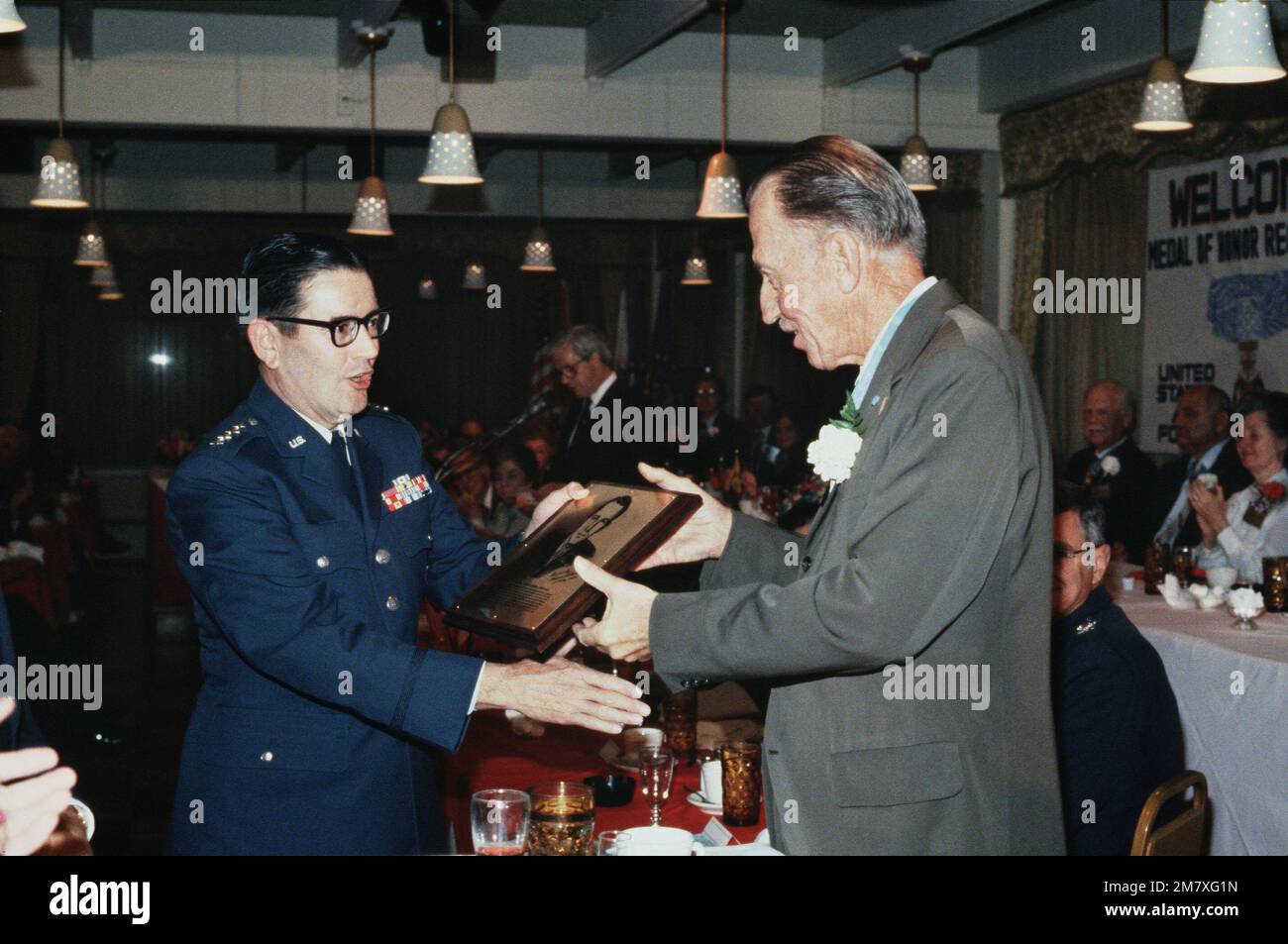 General (GEN) Robert T. March presents a memorial plaque to retired GEN James H. Howard, a World ...