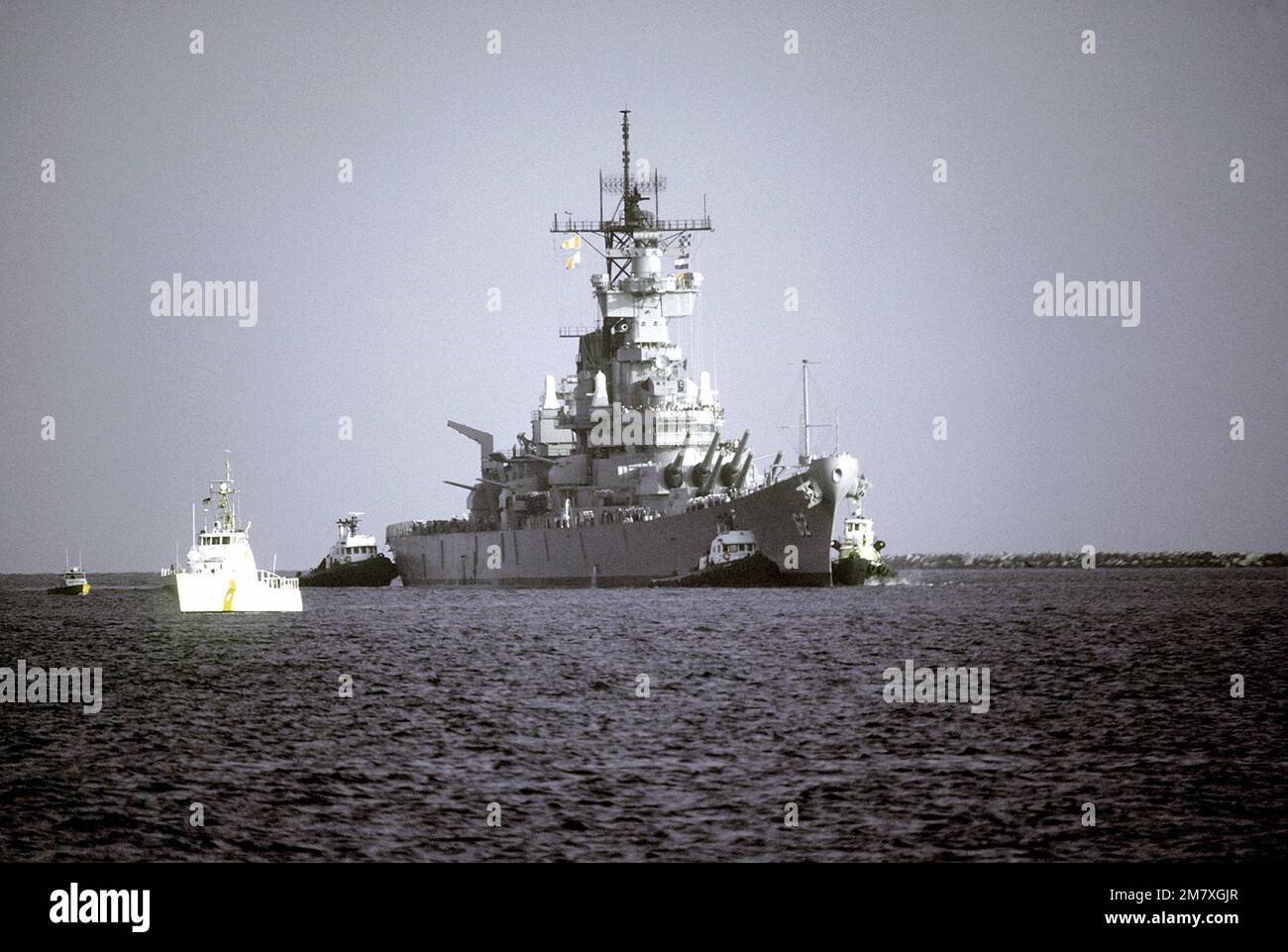 Starboard bow view of the battleship USS NEW JERSEY (BB-62) being towed ...