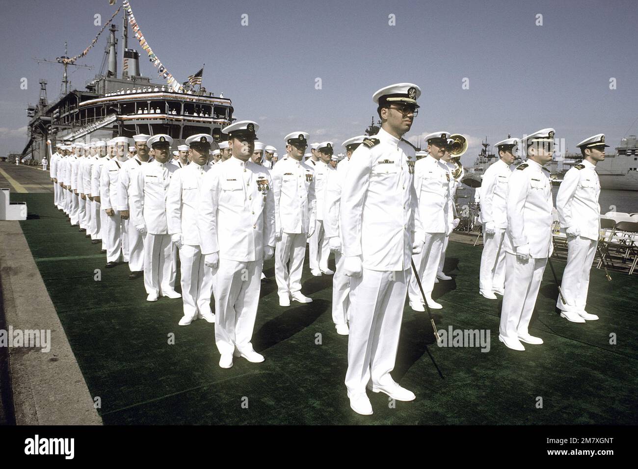 A view of the ship's crew in company formation and in dress whites ...