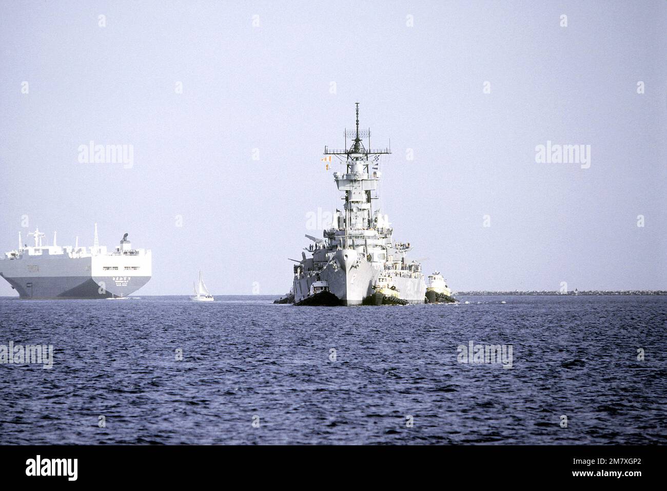 Bow view of the battleship USS NEW JERSEY (BB-62) being towed into the ...