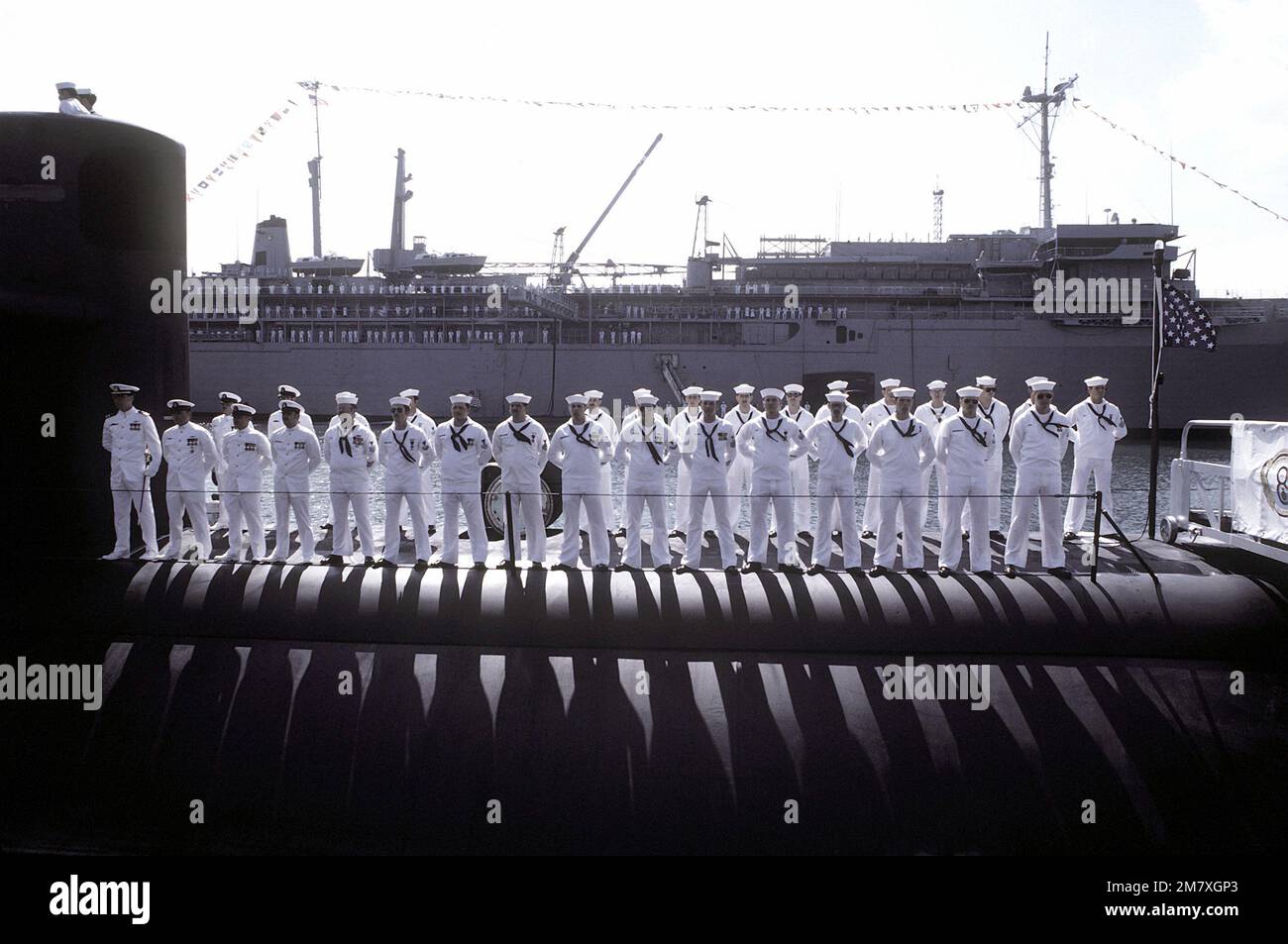 A view of the ship's company as they stand in formation on the weather ...