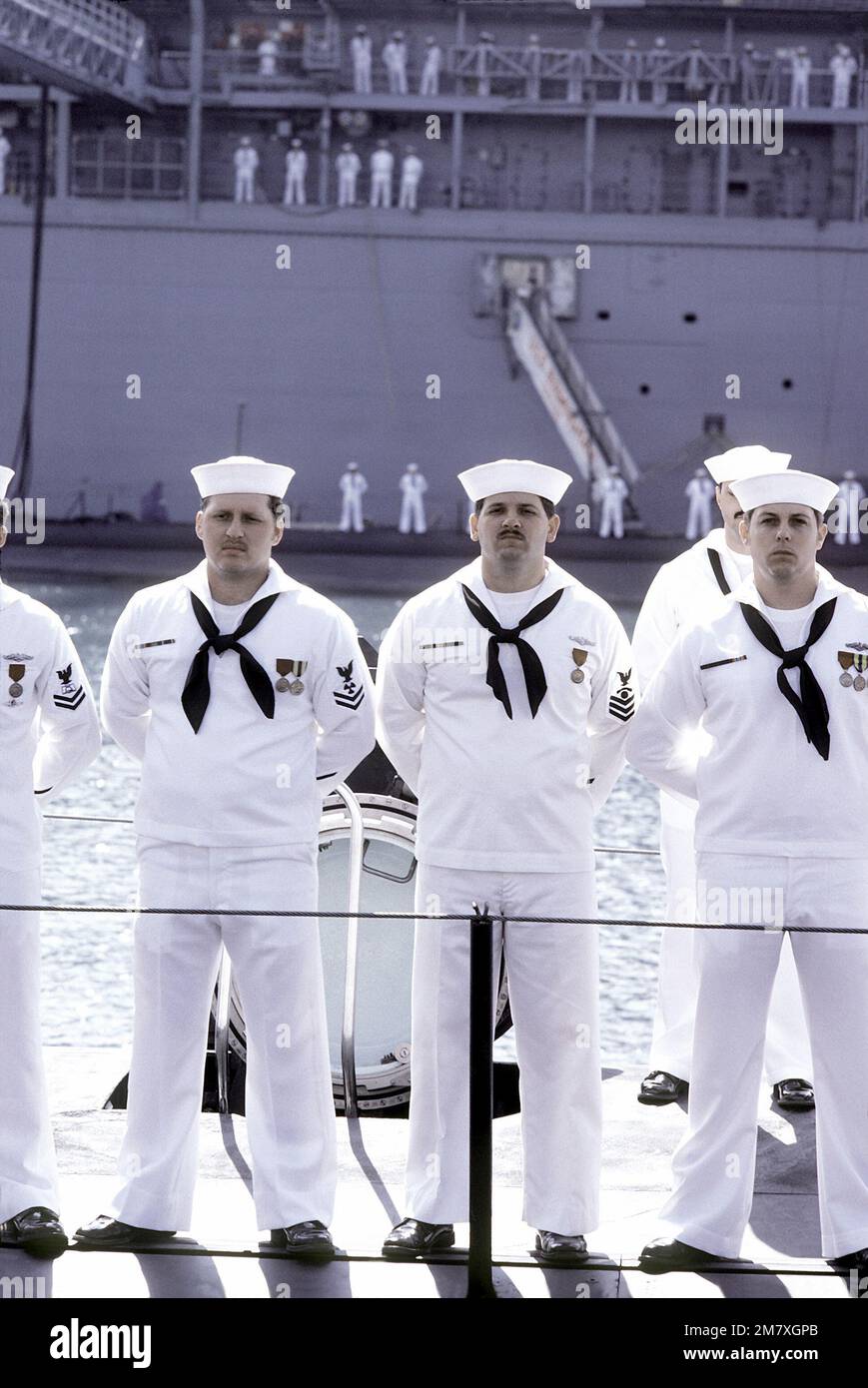 Part of the ship's crew stands in formation during the commissioning ...