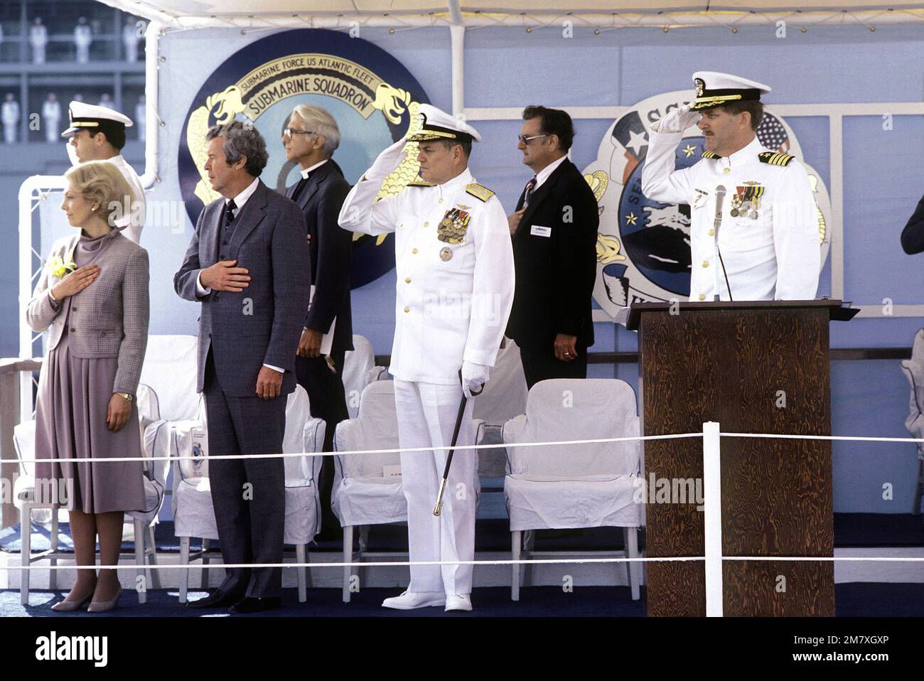 The honored guests and speakers salute the colors at the beginning of ...