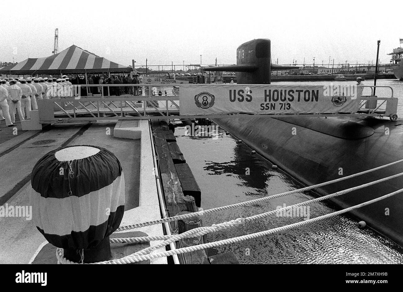 The ship's crew stand in company formation at the end of the ramp ...