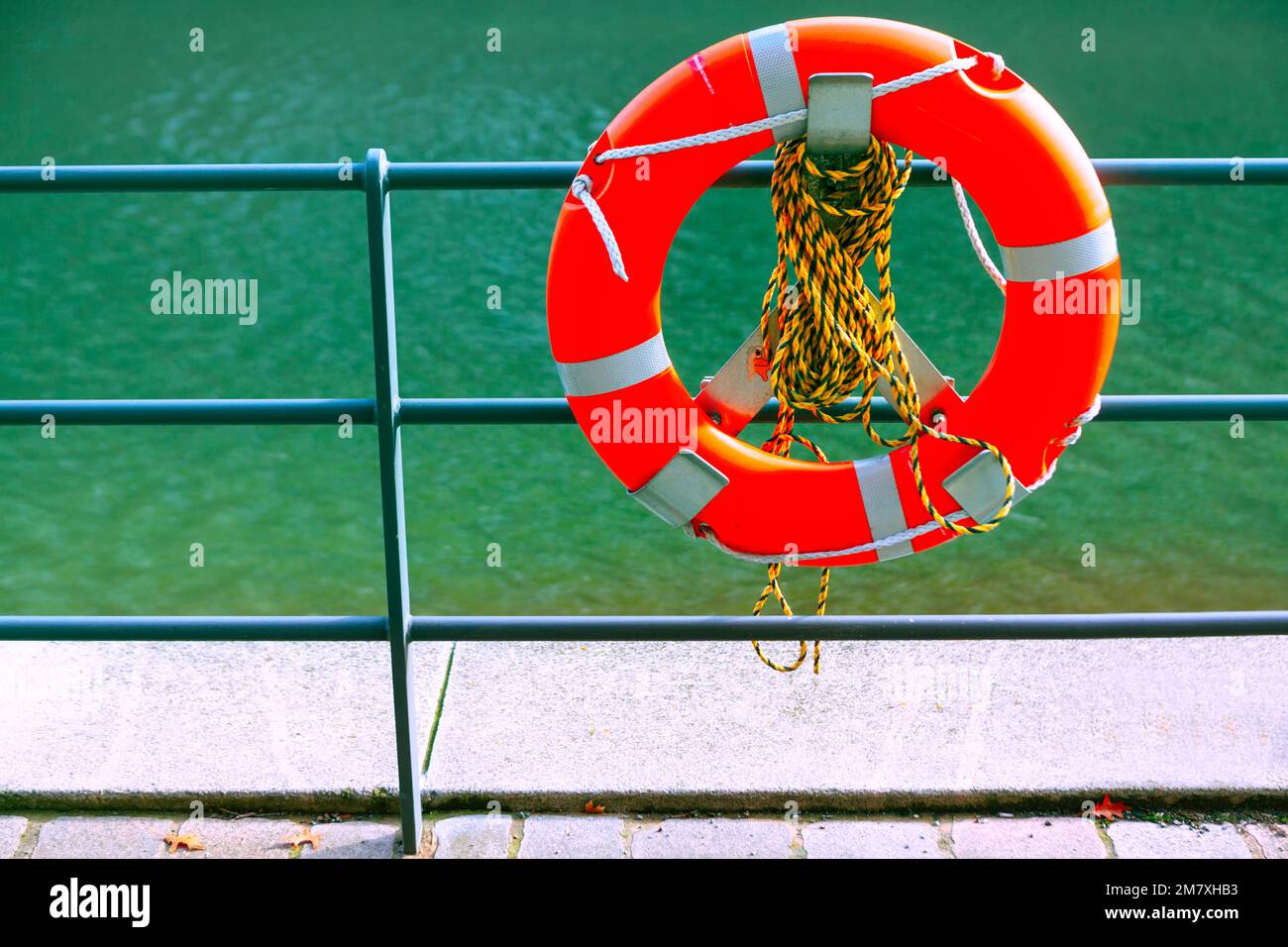 Lifebuoy with ropes . Lifebuoy ring at waterfront Stock Photo - Alamy