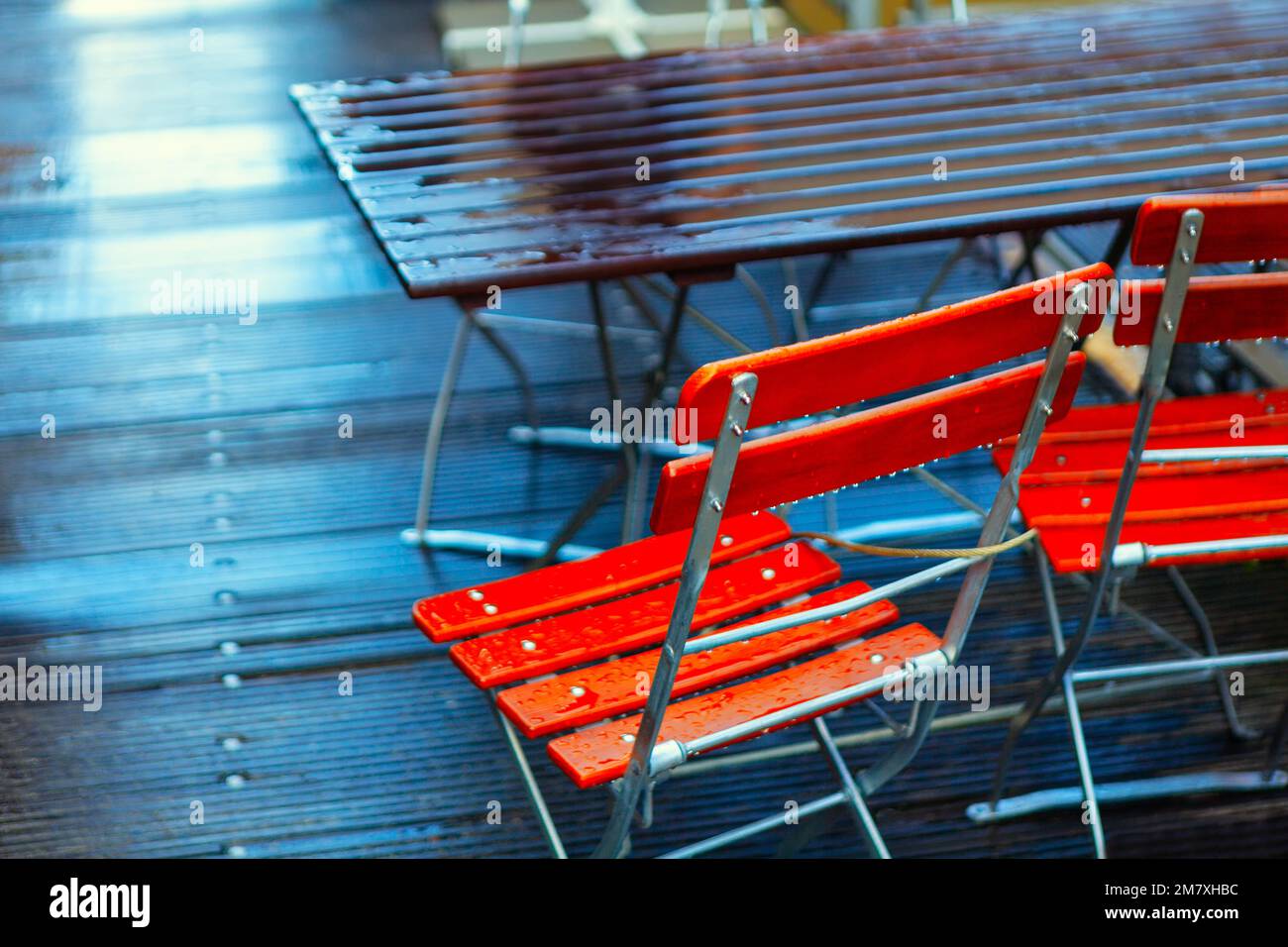 Outdoor terrace chairs and tables in raindrops . Street terrace in ...