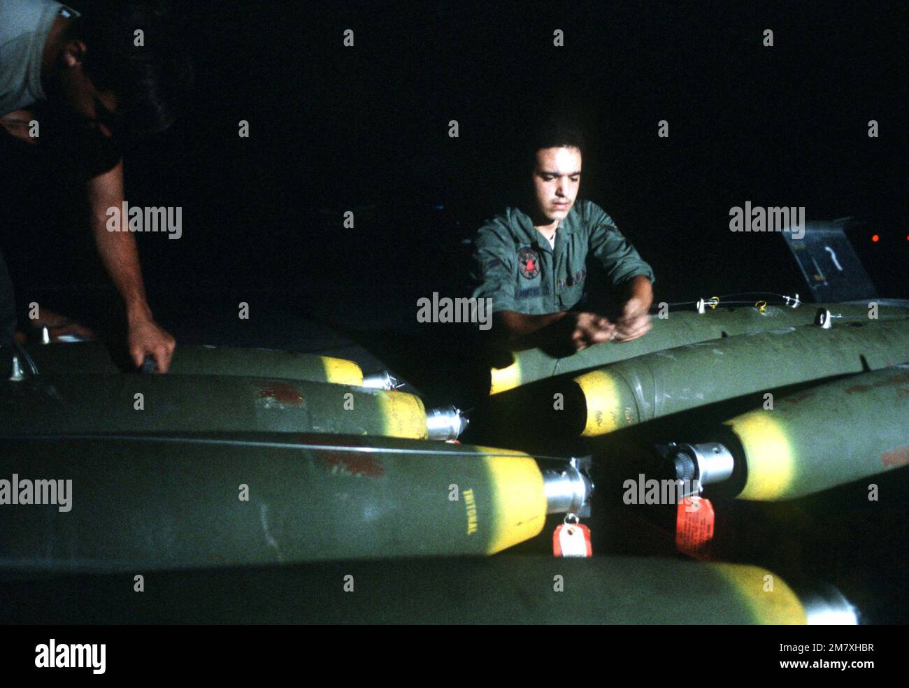 Members of the 3rd Munitions Maintenance Squadron attach safety wires ...