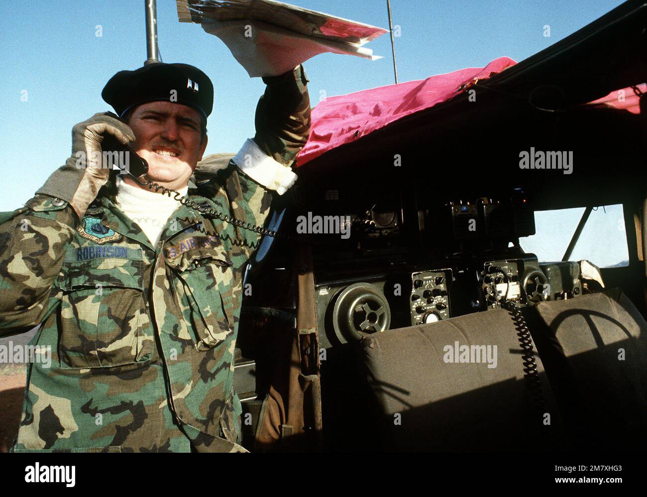 A forward air controller, using a radio, directs an F-4E Phantom II ...