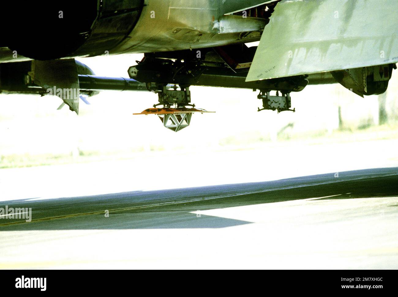 A view of a reflective laser device attached to the wing pylon of an F ...