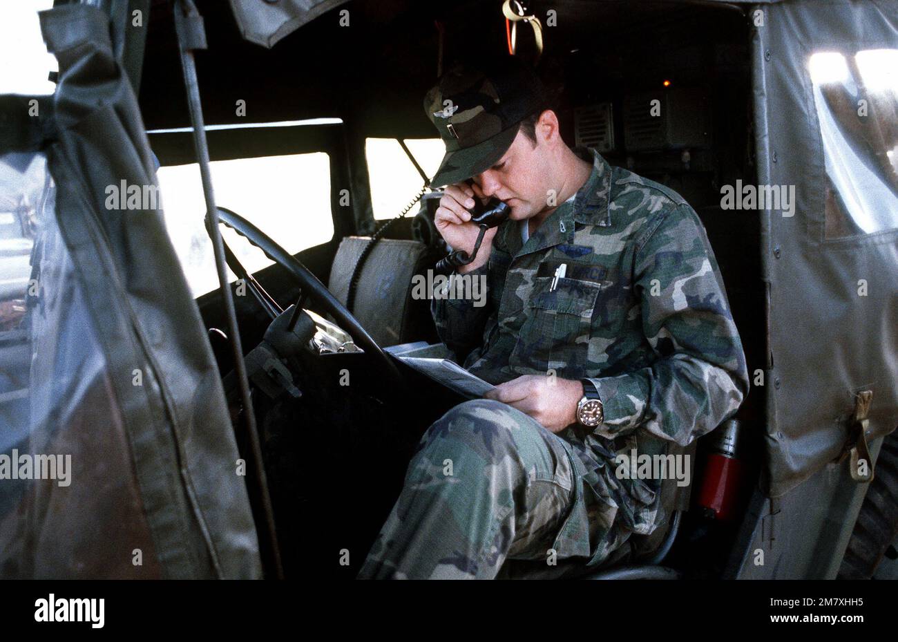 A forward air controller, using a radio, directs an F-4 Phantom II ...