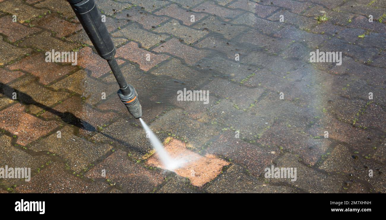 High Pressure Cleaning concrete block floor by water jet Stock Photo ...