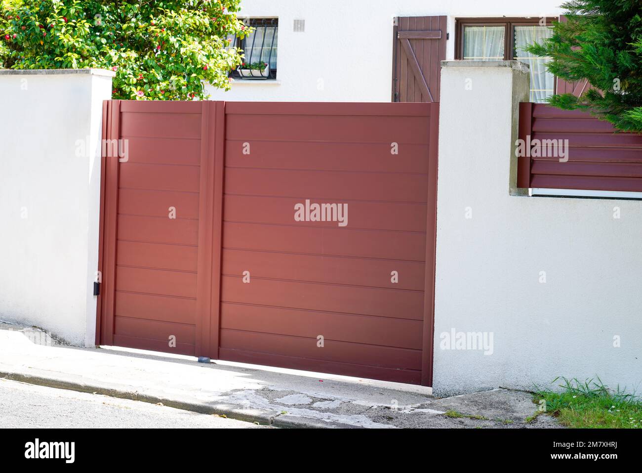 Aluminum dark red metal gate of suburb house door Stock Photo - Alamy