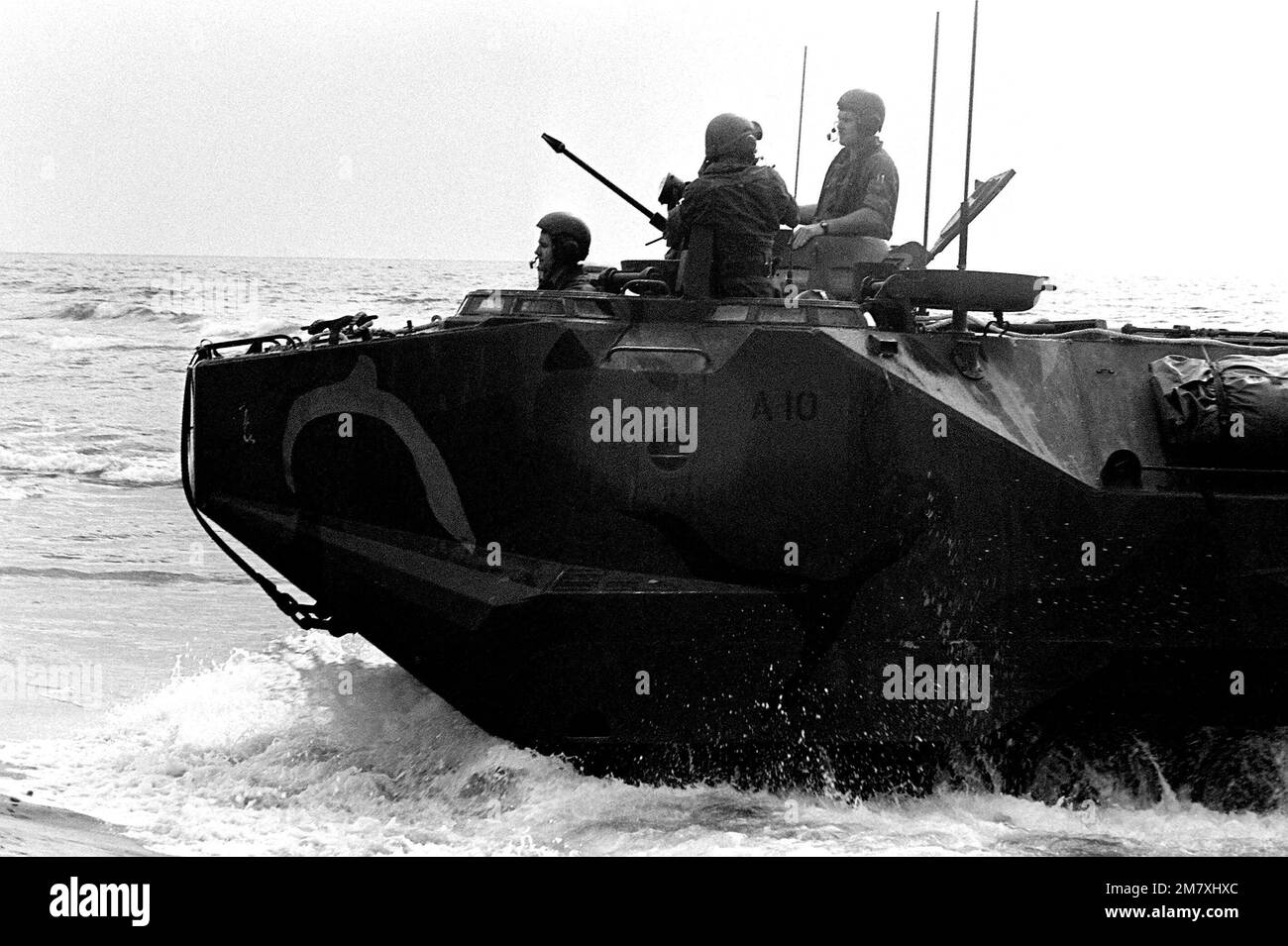An LVTP7 tracked landing vehicle is driven ashore by Marine of the 32nd ...