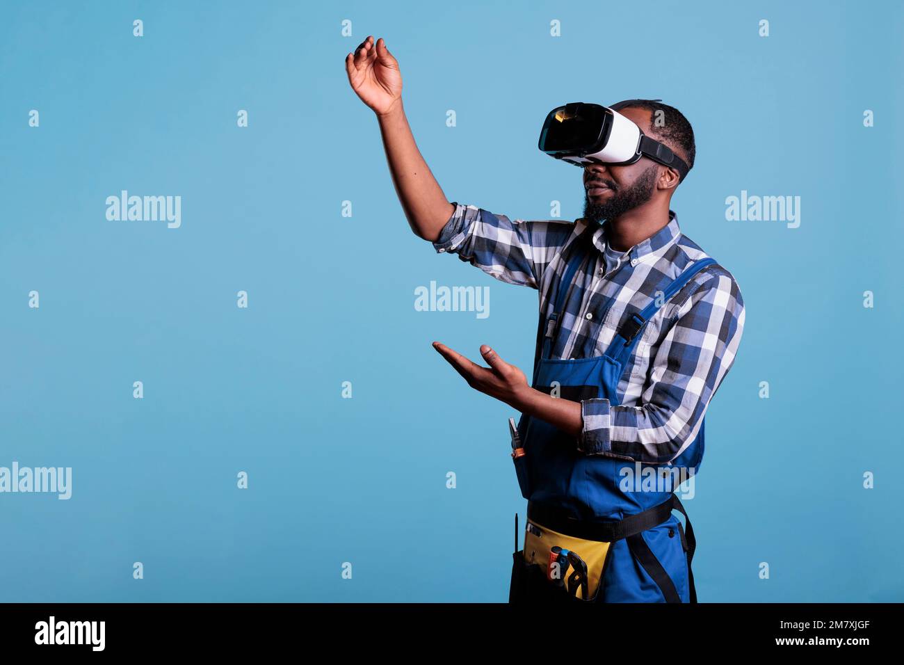 African american builder wearing virtual reality goggles in a ...
