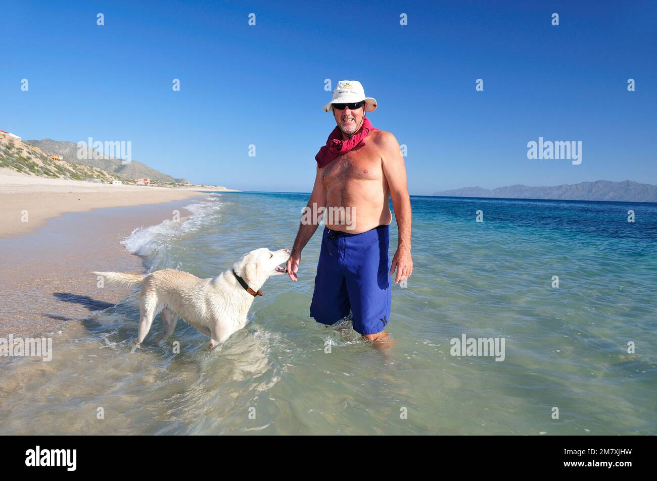 Owner Mr. Bill of Ventana Bay Resort with his dog Blanca at Beach ...