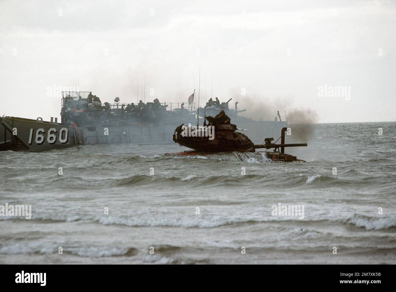 A Marine M-60 main battle tank is driven ashore from Utility Landing ...