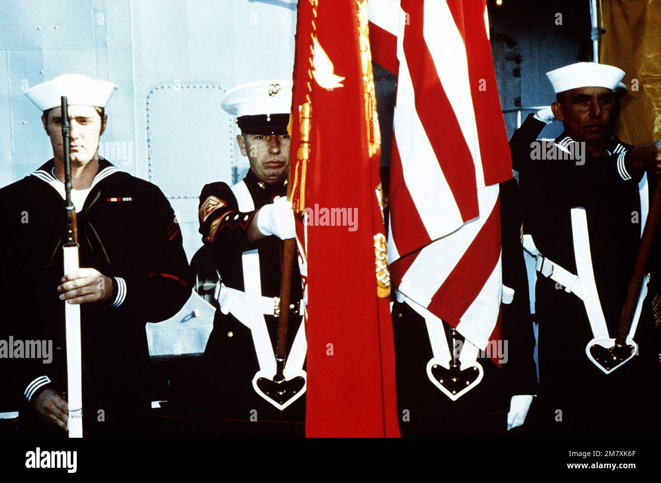 The colors are paraded by a combined Navy/Marine Corps color guard ...