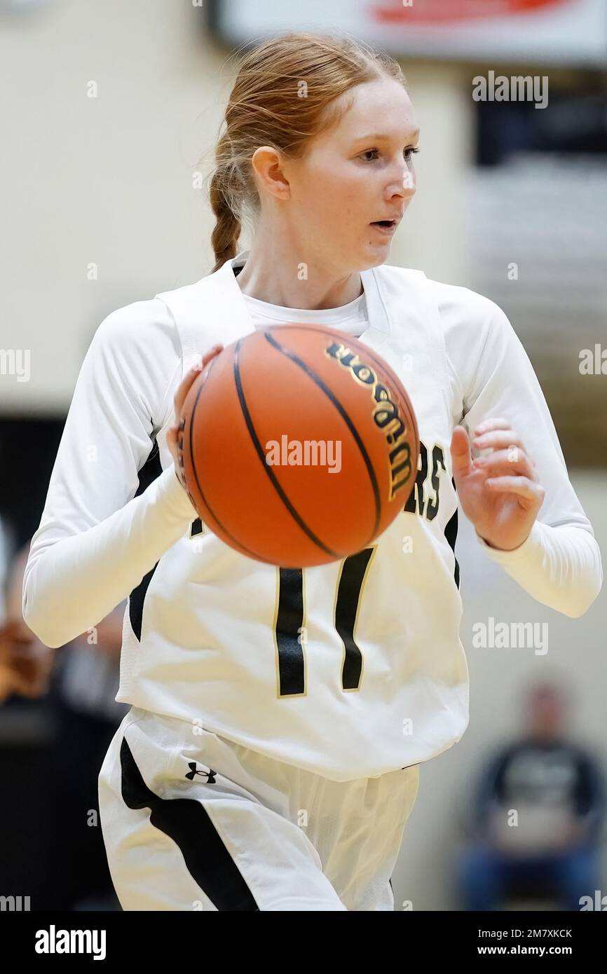 A vertical shot of a young female player on a court at a girls fall ...