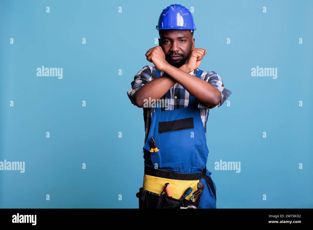 Disapproving african american builder making stop gesture with crossed ...