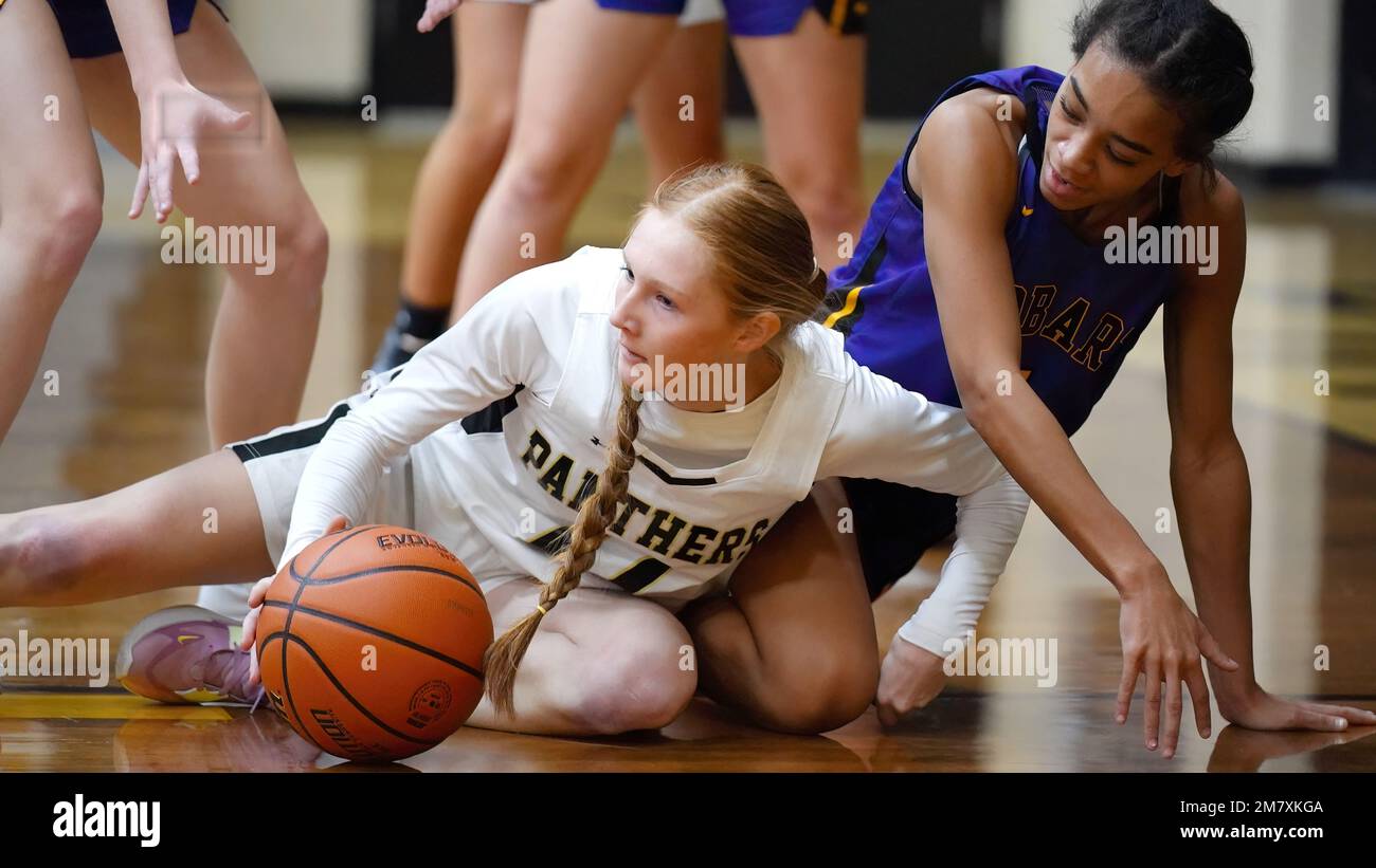 The young female players on an indoor court at a girls fall high school ...