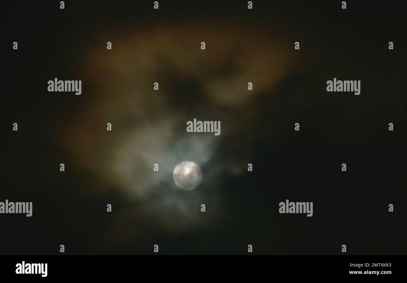 full moon cover by spreading cloud in night Stock Photo - Alamy