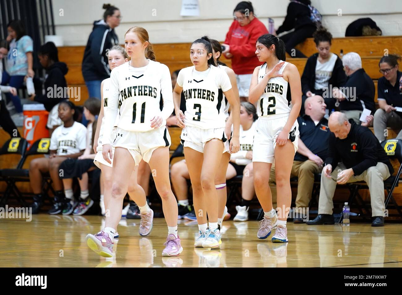 The young female players on an indoor court at a girls fall high school ...